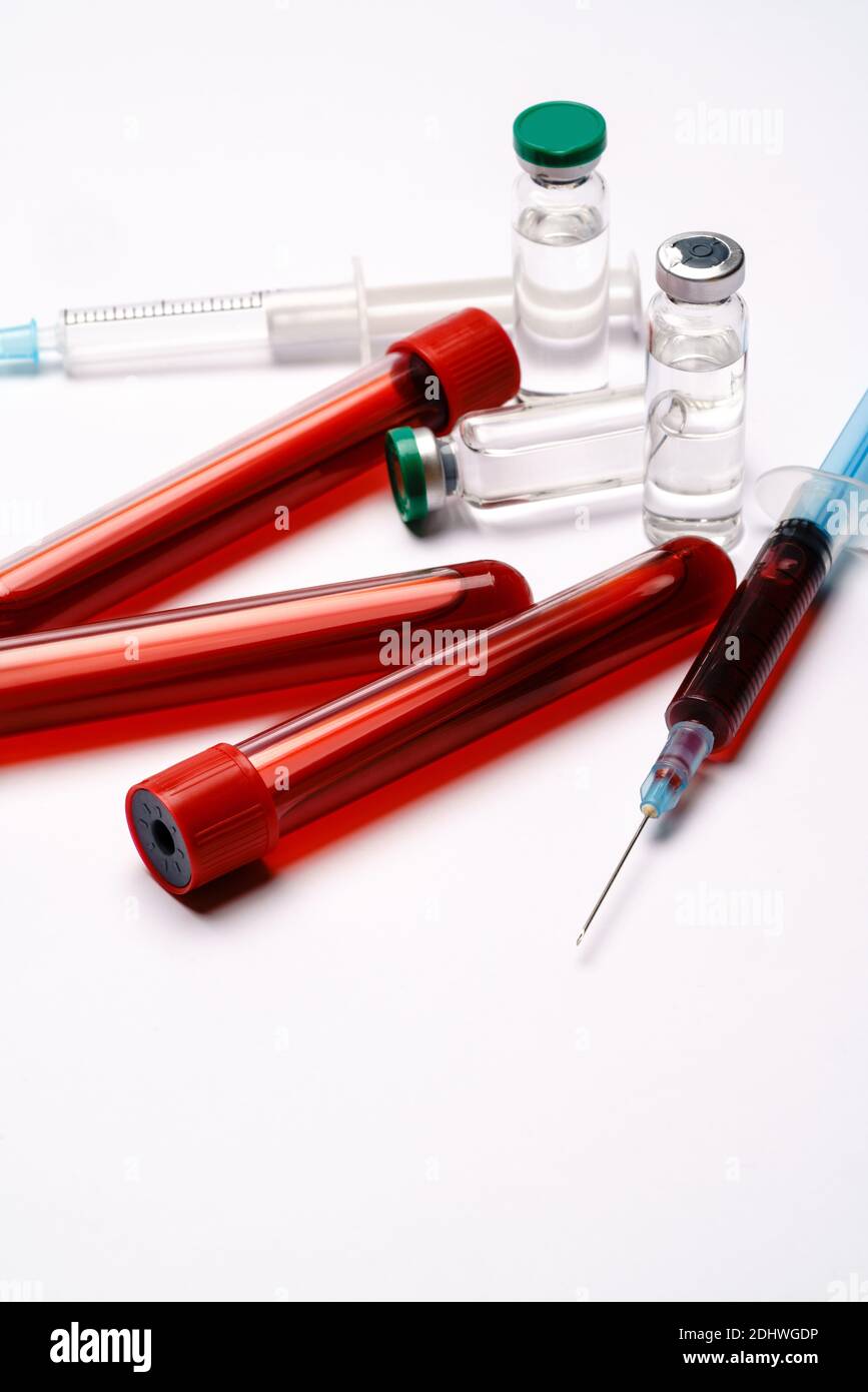 medical ampoule vials, test tubes with blood samples and syringe on ...