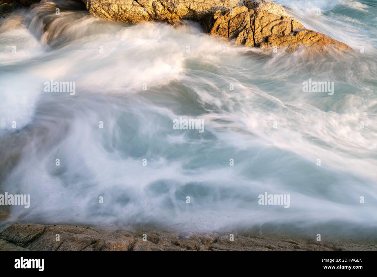 Beautiful long exposure seascape with sea wave forms a dense white foam ...