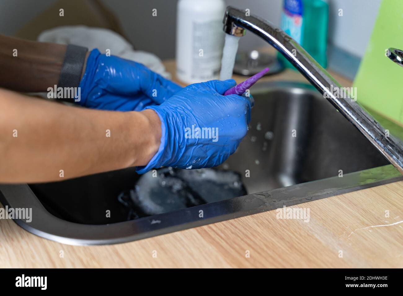 Beauty and hygiene industry. Master in medical gloves washes tools with ...