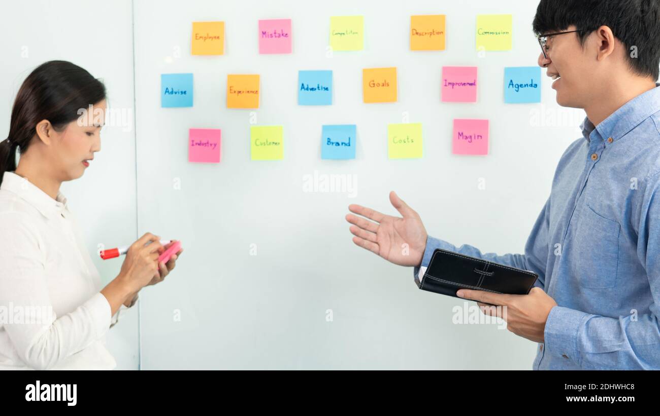 business teamwork in meeting and adhesive stick note on mirror board ...