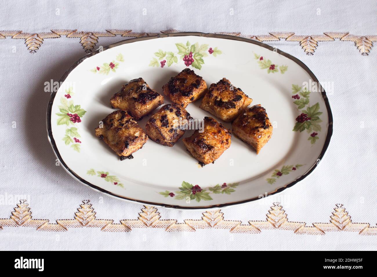 Some hake loins in butter with garlic and paprika on a decorated ...