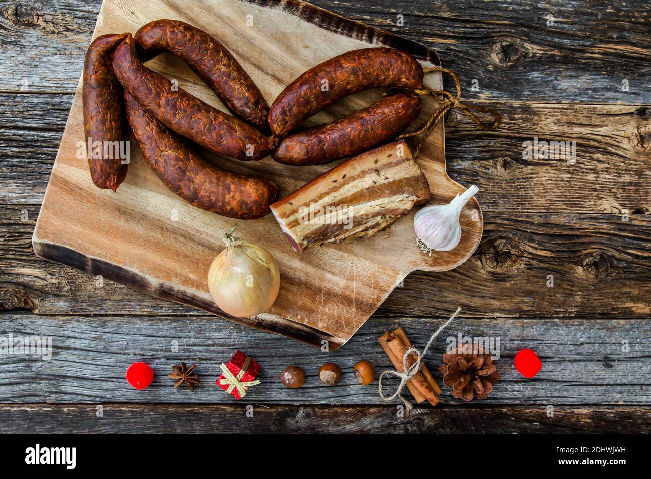 Table top view with home made bacon and sausages and Christmas decor on ...
