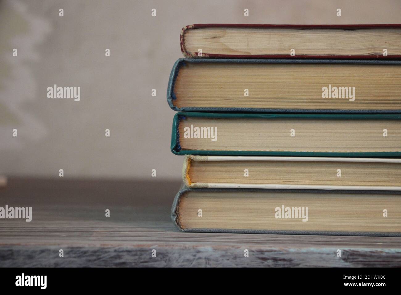 Five books on old table egde. Knowledge conceptfocus selected Stock ...