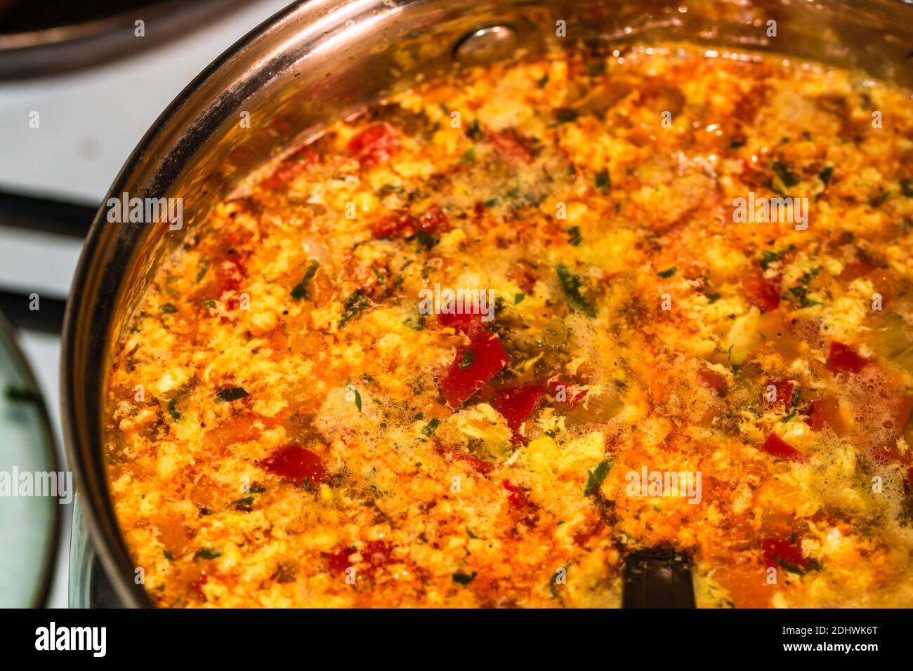 Preparation of soup with chicken and vegetables. Close up of boiling ...