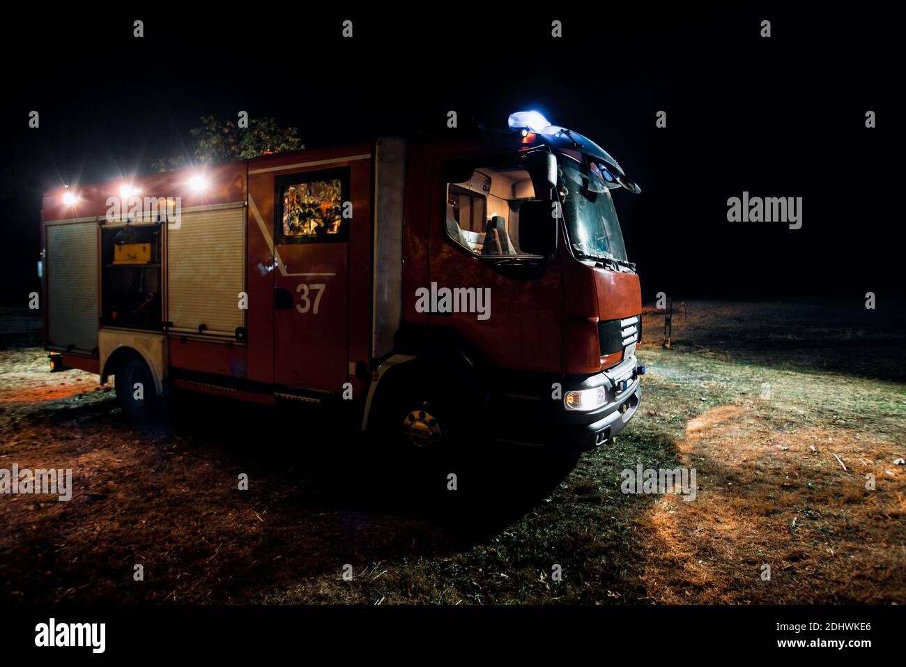 Firefighter pumper truck operating in the field Stock Photo - Alamy