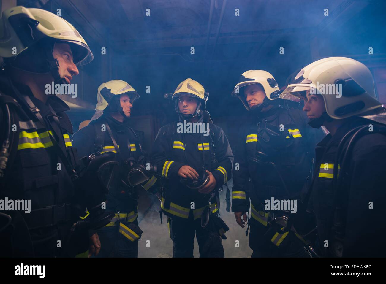 Group of firemen in the fire department organizing action plan for safe ...