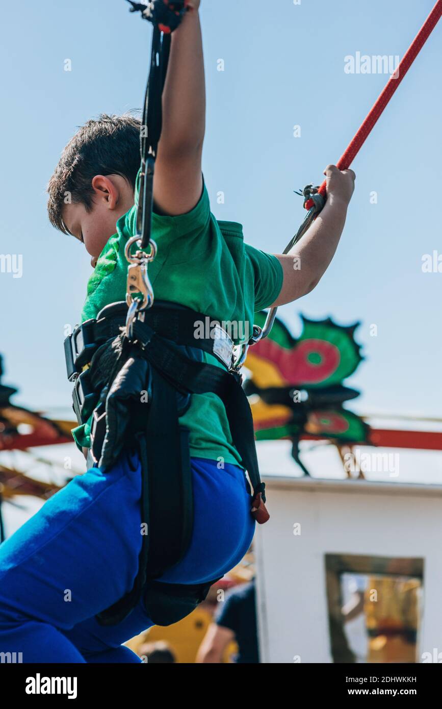 Little boy jumping on the trampoline with rubber bands Stock Photo - Alamy