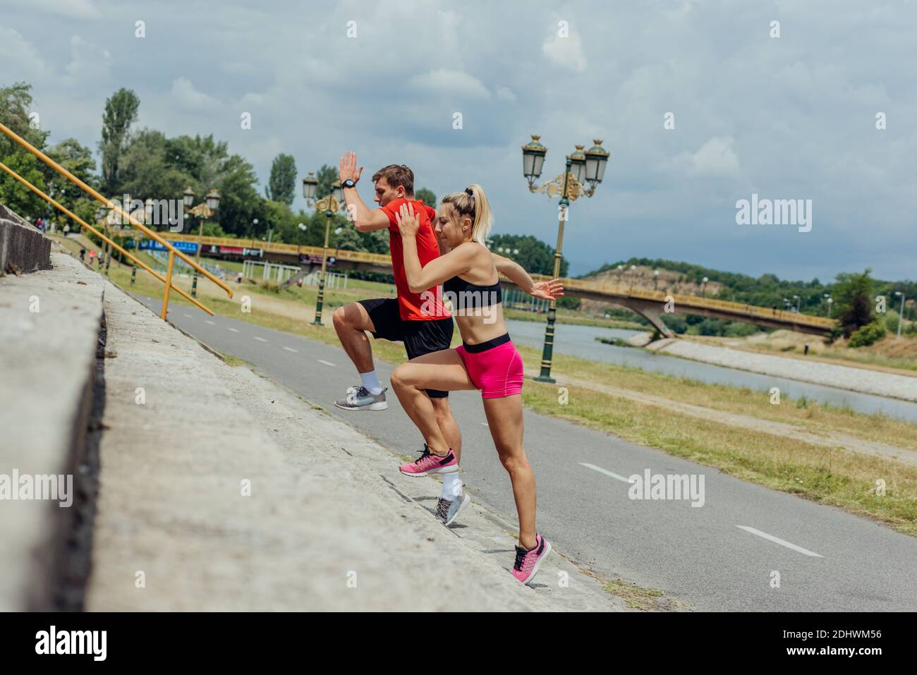 Healthy active couple exercising cardio and sprinting staircase in a ...