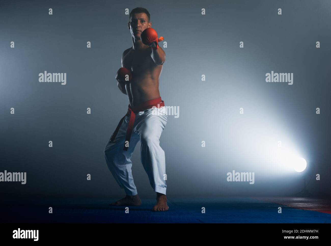 A young strong man in a white kimono for sambo, jiu jitsu and other ...