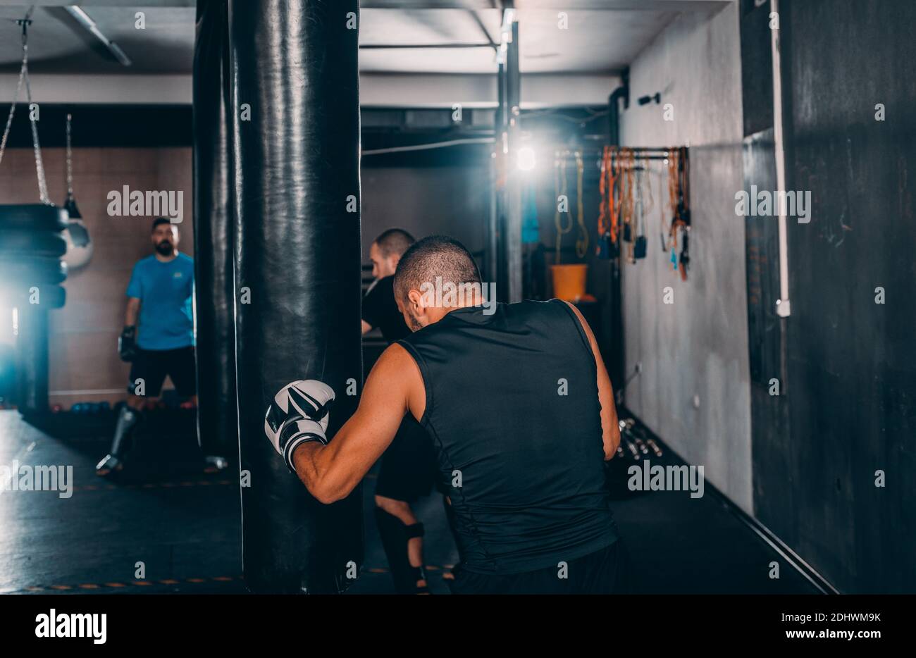 Muscular handsome fighter giving a forceful forward kick during a ...