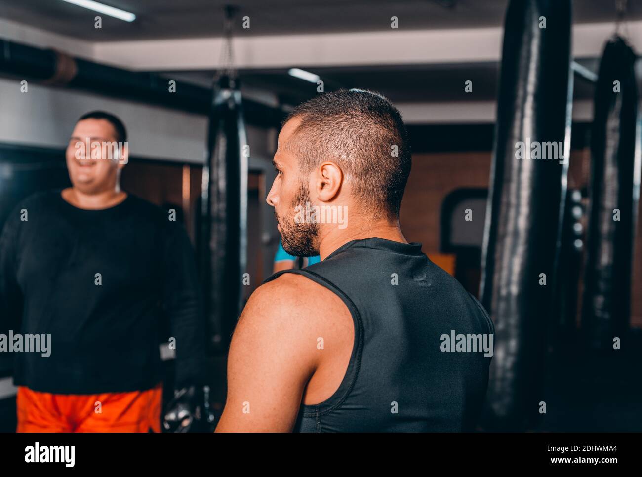 Lifestyle gym portrait of young attractive and fierce looking man ...