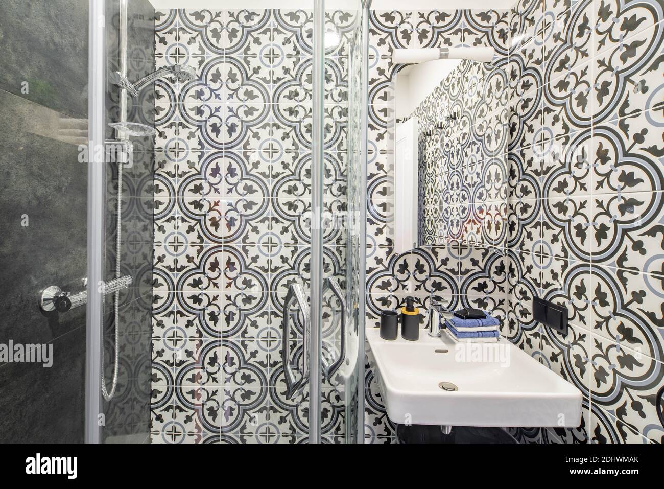 Modern interior of bathroom. Shower cabin. White sink and mirror. Patterned tile Stock Photo - Alamy