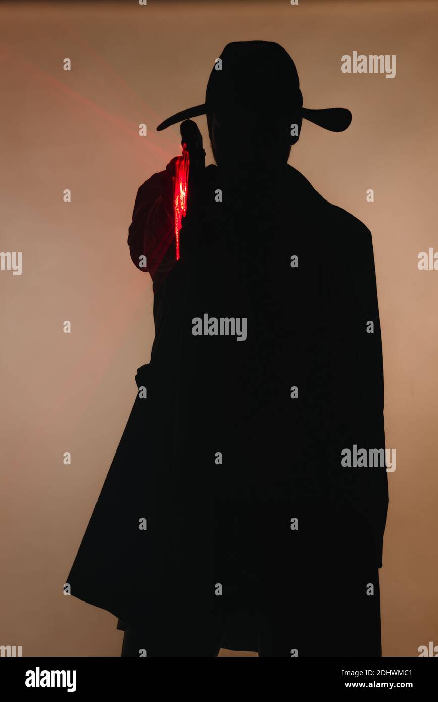 Studio portrait of a cosplayer wearing a ultramodern hitman costume ...