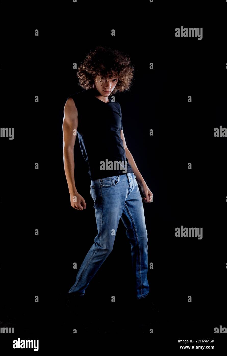 Fashion model posing wearing rock clothing isolated on black wall Stock ...