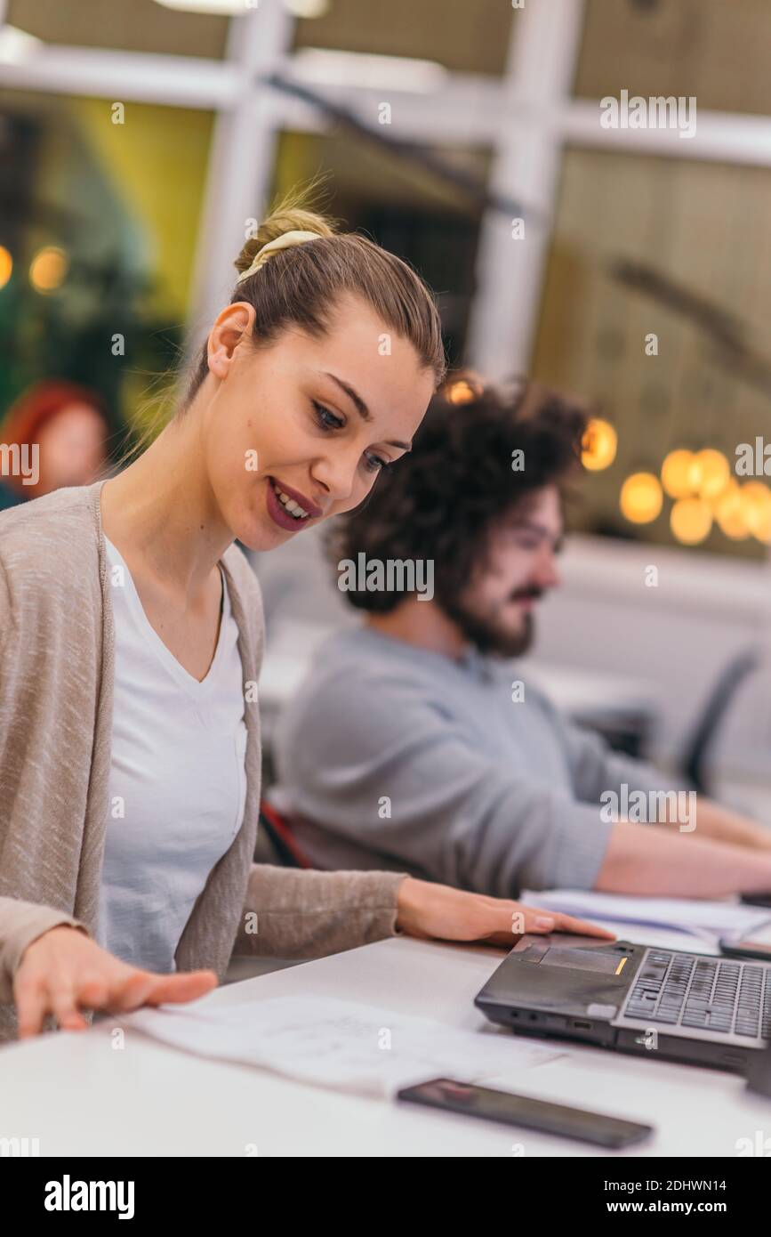 Two colleagues working on a project in modern startup offices. Guy with ...