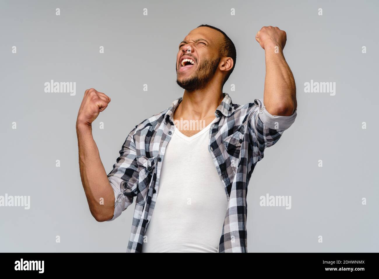 Photo of emotional screaming young african-american man standing over ...