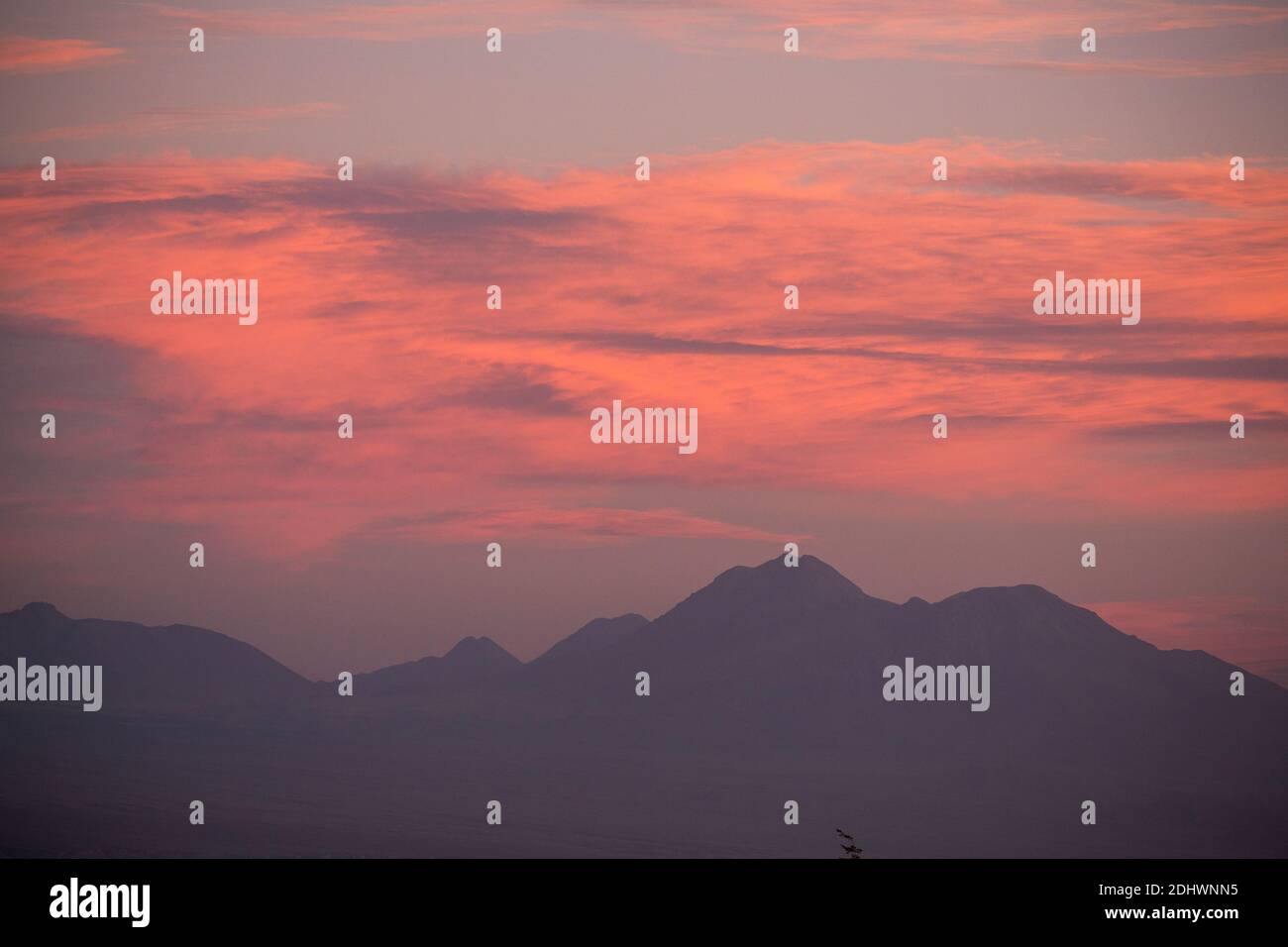 Sunset over the volcanoes and mountains of the Andes at San Pedro de ...
