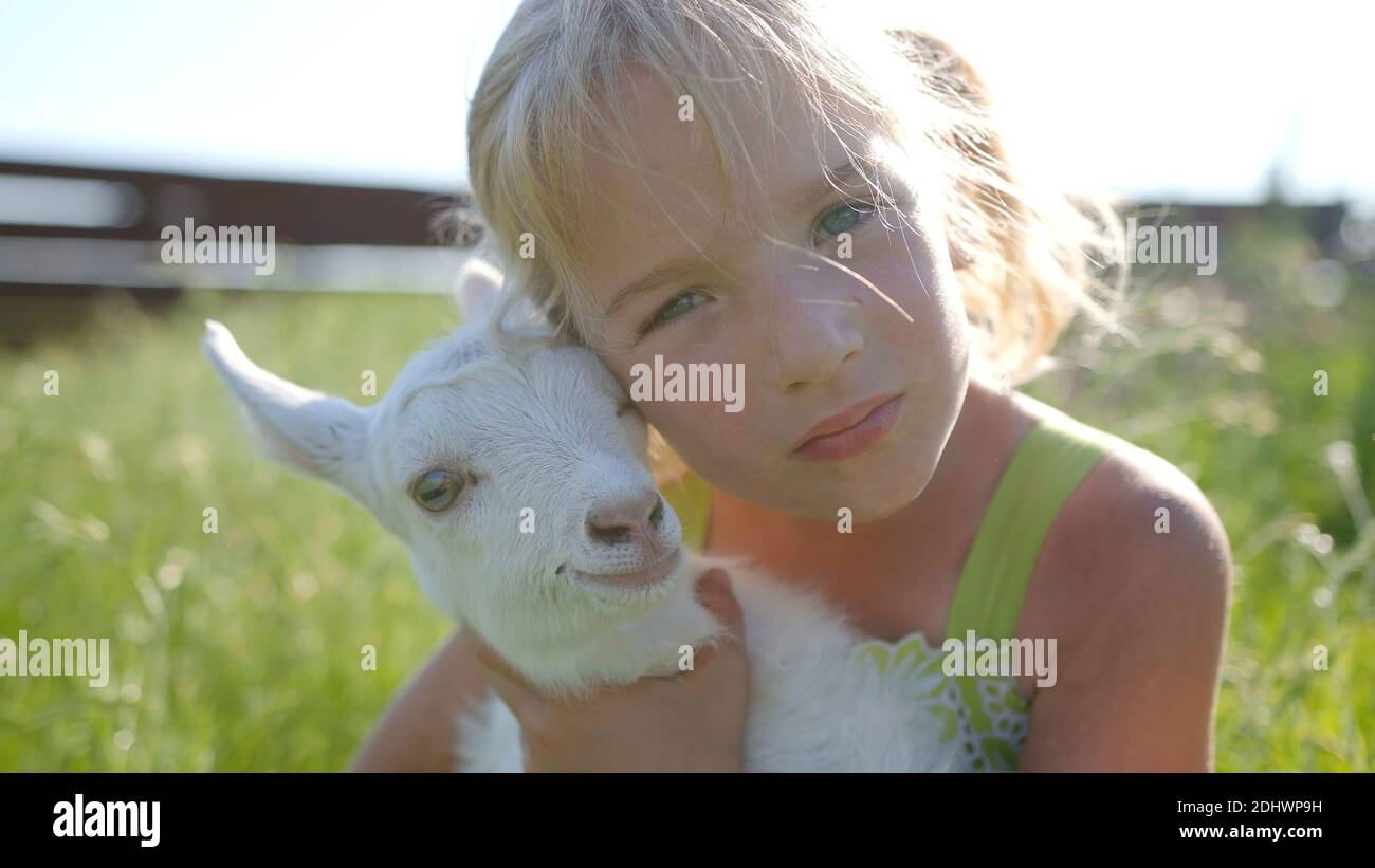Child hugging goat hi-res stock photography and images - Alamy