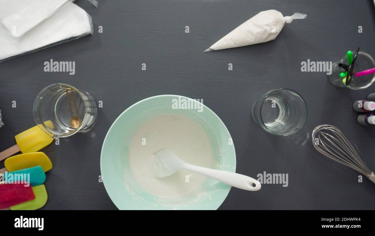 Step by step. Flat lay. Pouring royal icing into the piping bag to ...