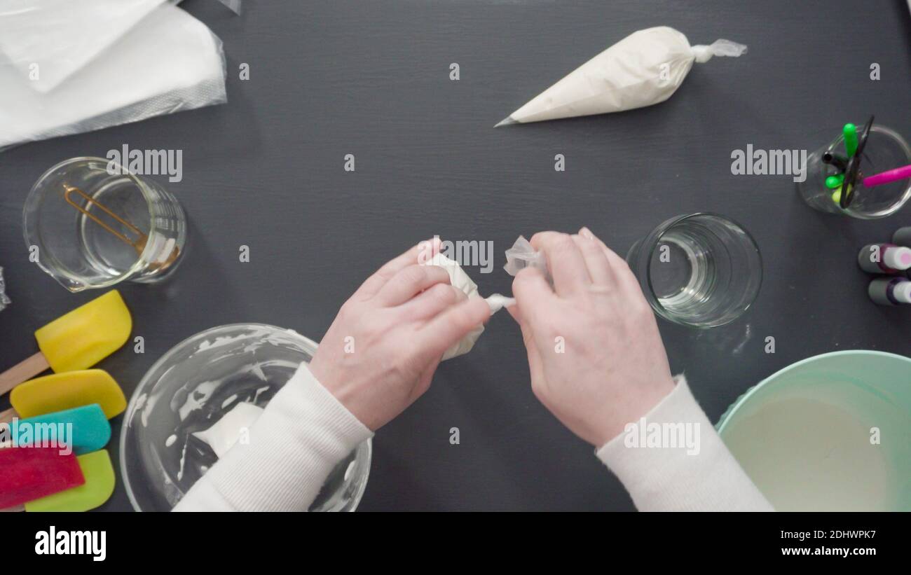 Step by step. Flat lay. Pouring royal icing into the piping bag to ...