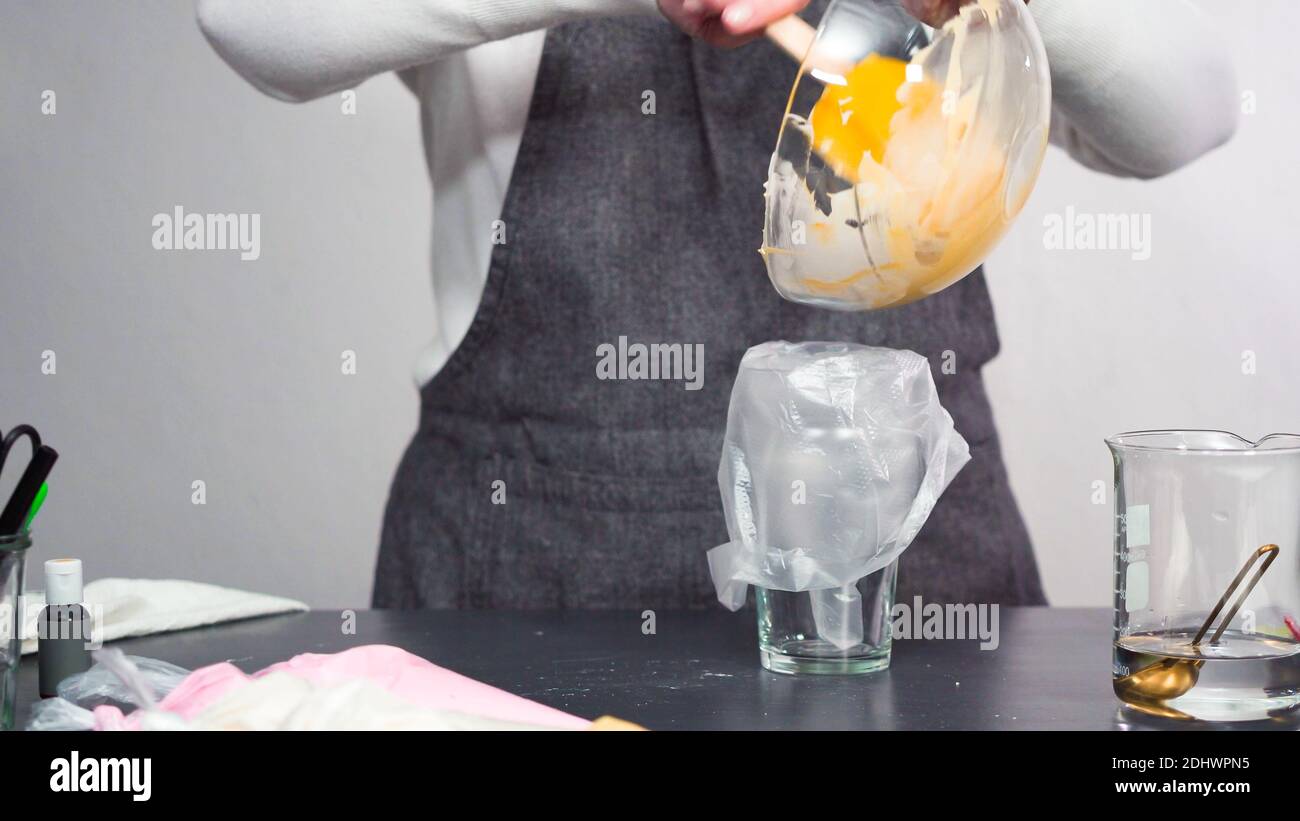 Step by step. Pouring royal icing into the piping bag to decorate sugar ...