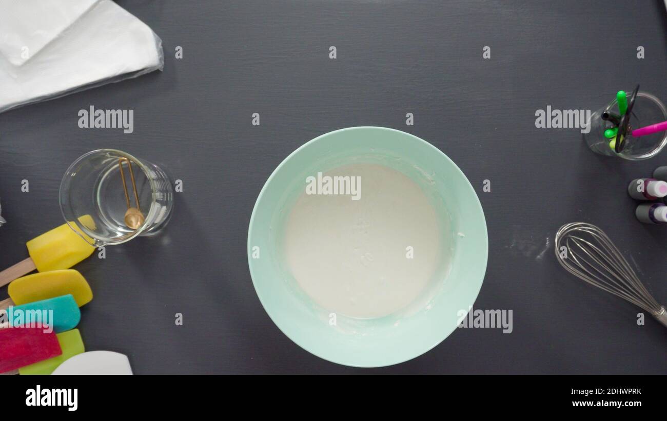 Step by step. Flat lay. Pouring royal icing into the piping bag to ...