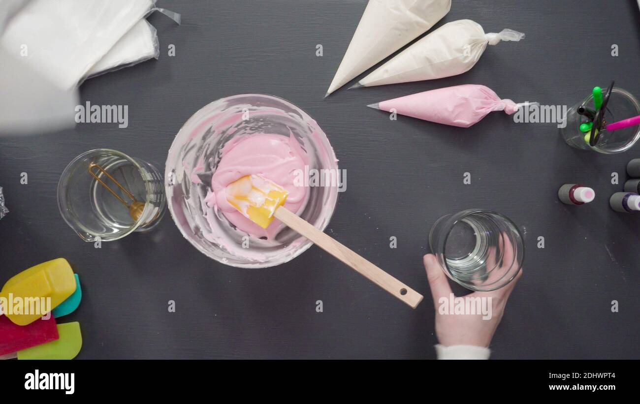 Step by step. Flat lay. Pouring royal icing into the piping bag to ...