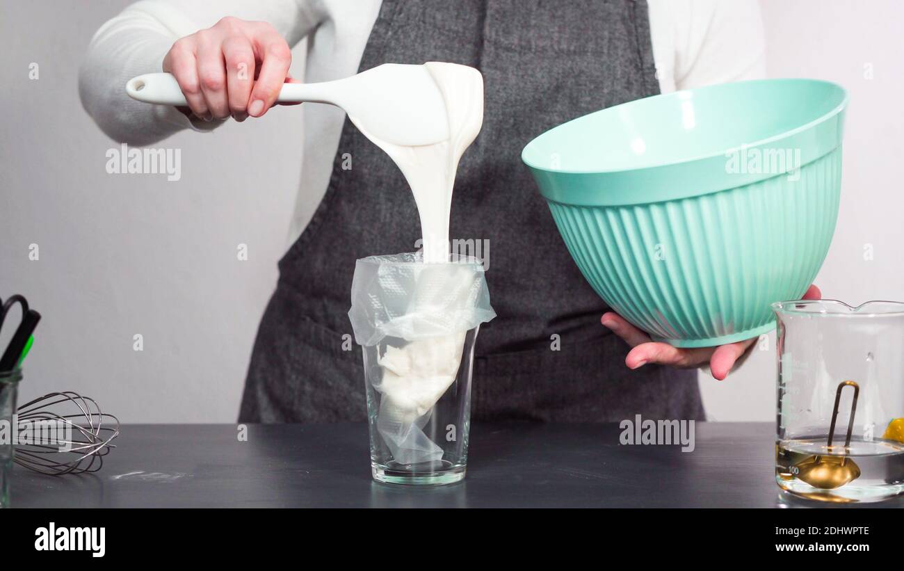 Step by step. Pouring royal icing into the piping bag to decorate sugar ...