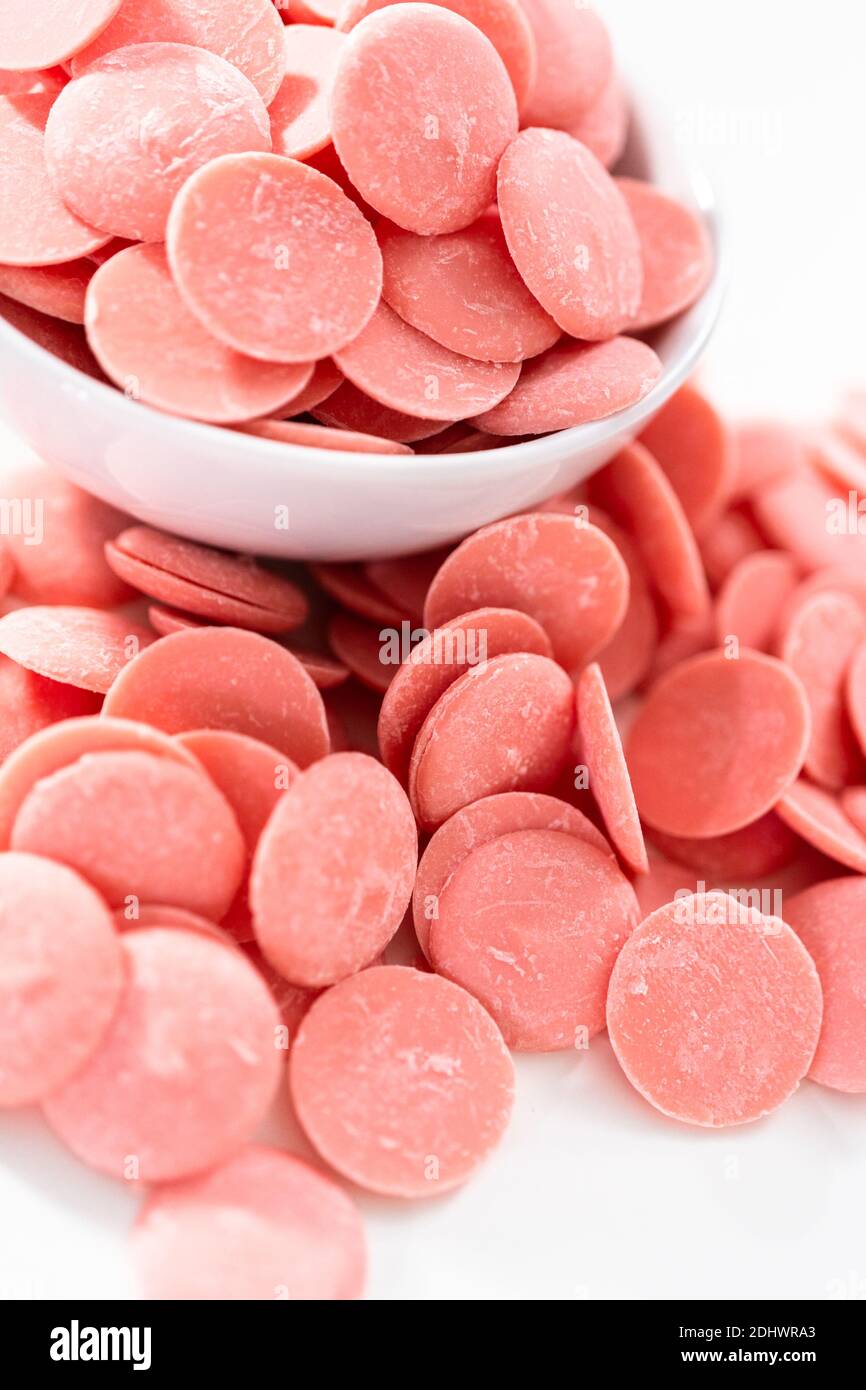 Pink round chocolate chips for melting chocolate shapes on a white ...