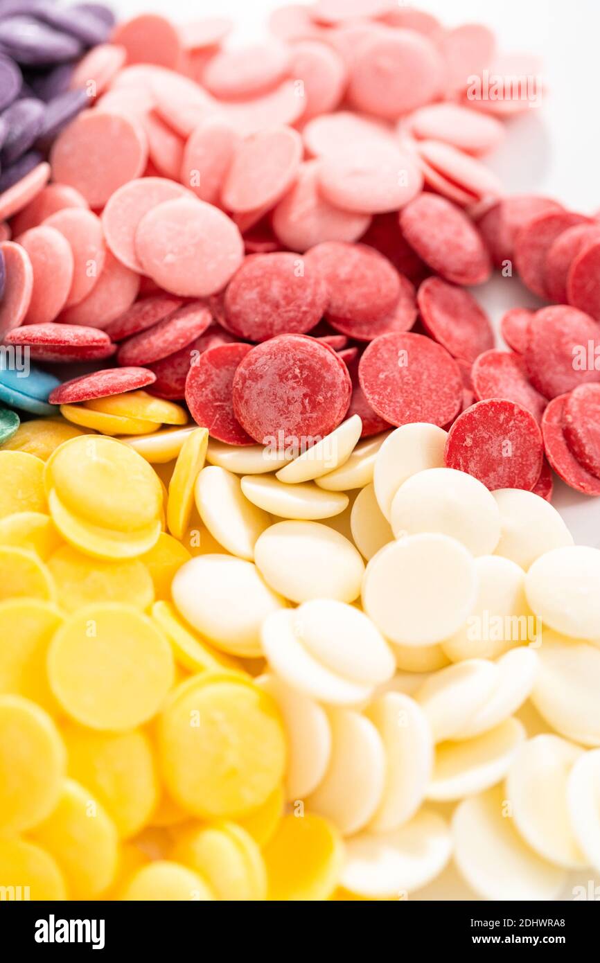 Rainbow colors of round chocolate chips for melting chocolate shapes on ...