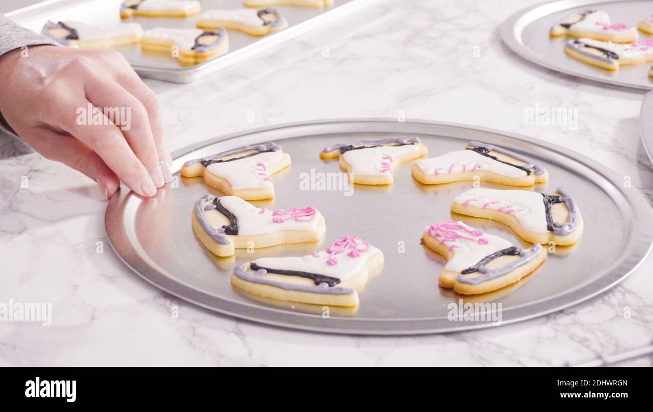 Icing figure skate shaped sugar cookies with royal icing Stock Photo ...