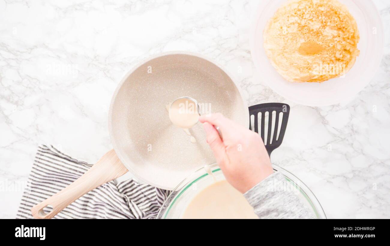 Flat lay. Making crepes in a small frying pan over medium heat Stock ...