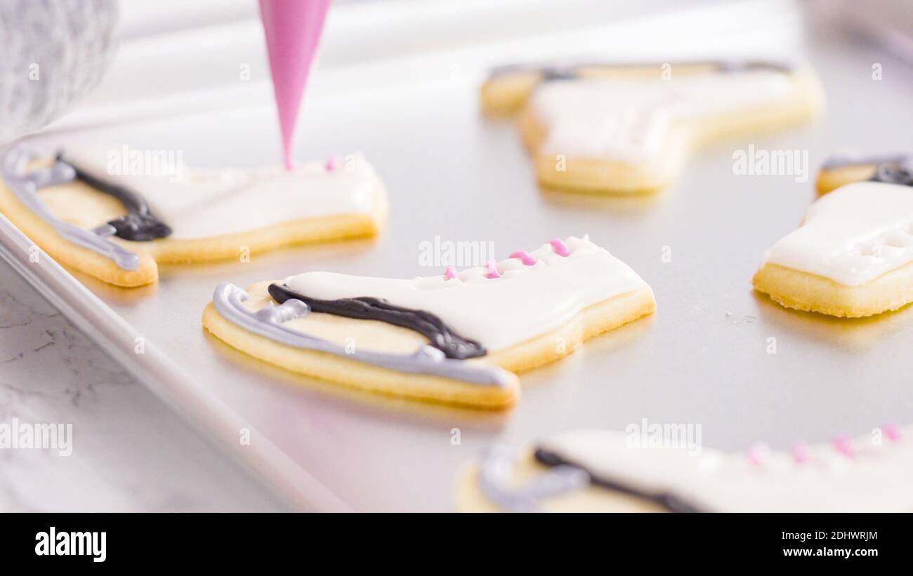 Icing figure skate shaped sugar cookies with royal icing Stock Photo ...