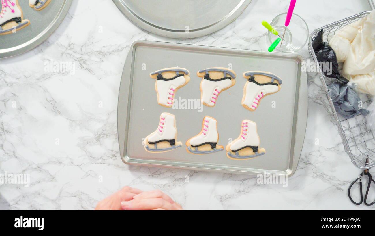 Flat lay. Icing figure skate shaped sugar cookies with royal icing ...