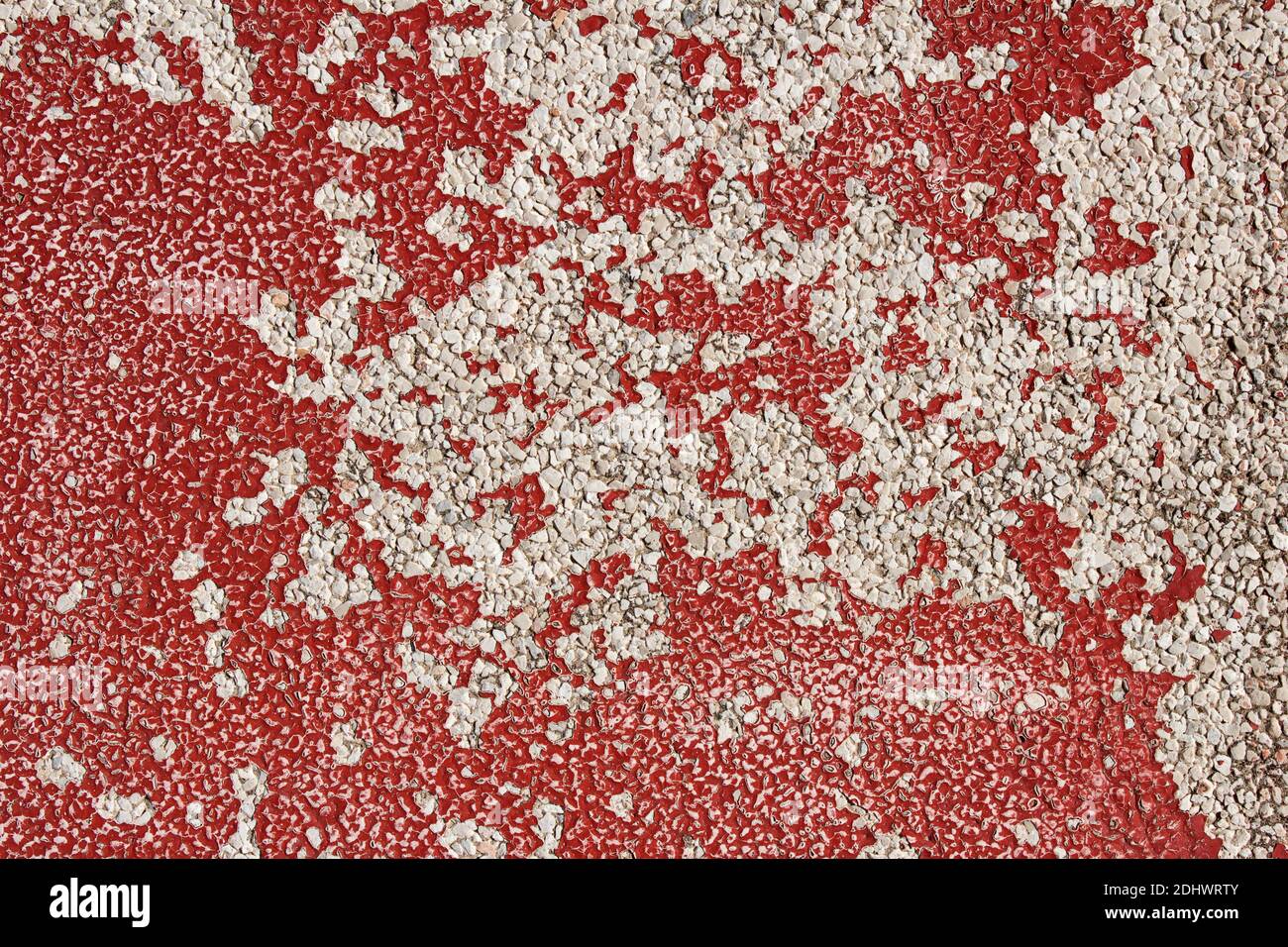 Background texture with red paint peeling and separating from an ...
