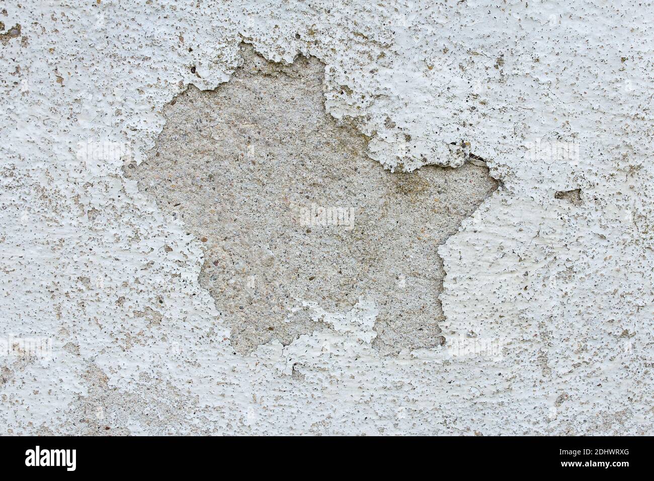 Peeling paint in the middle of a chipping white wall. Retro and vintage ...