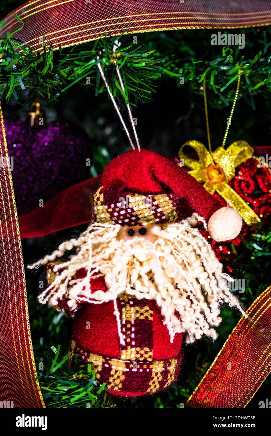 Decorating Christmas tree, hand putting Christmas decorations on fir ...