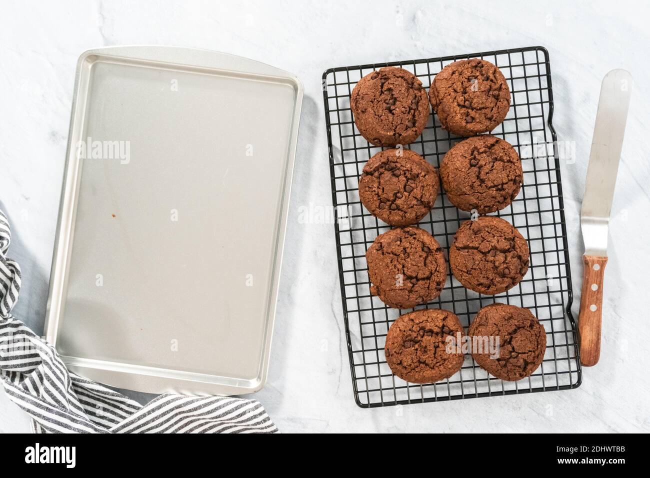 Flat lay. Freshly baked double chocolate chip cookies on a cooling rack ...