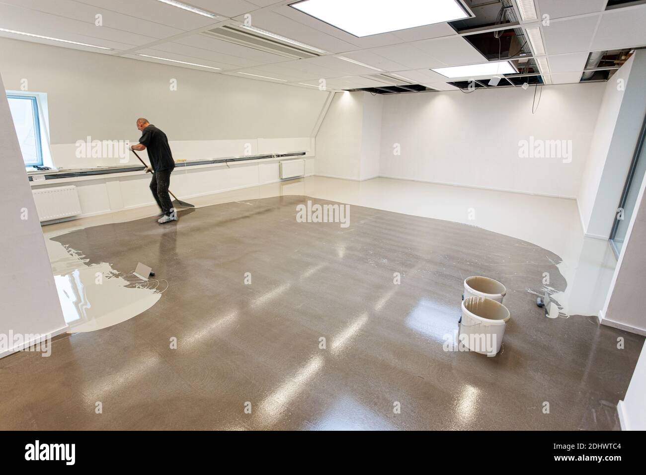 LAREN, THE NETHERLANDS - MAY 16, 2012: Construction workers applying a ...