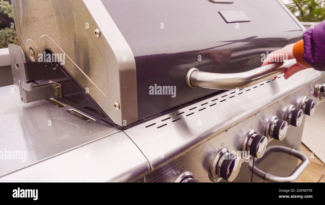 Cooking bacon stips on an outdoor gas grill Stock Photo - Alamy