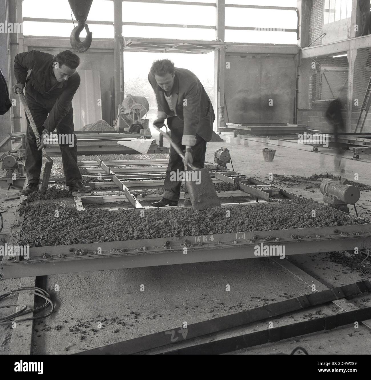 1960s, historical, workmen with shovels putting concrete into moulds ...