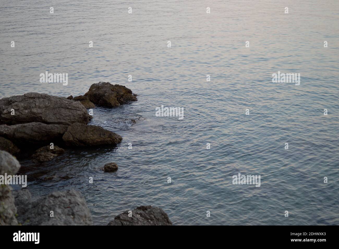 Rocks at the beach, calm water, small waves, clear water Stock Photo ...