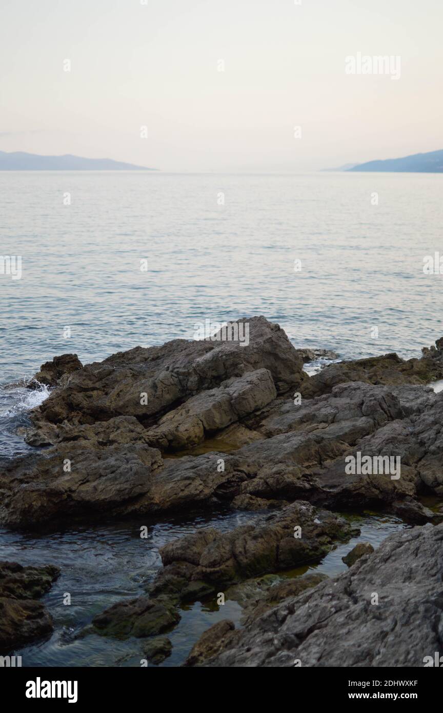 Rocks at the beach, calm water, small waves, clear water Stock Photo ...