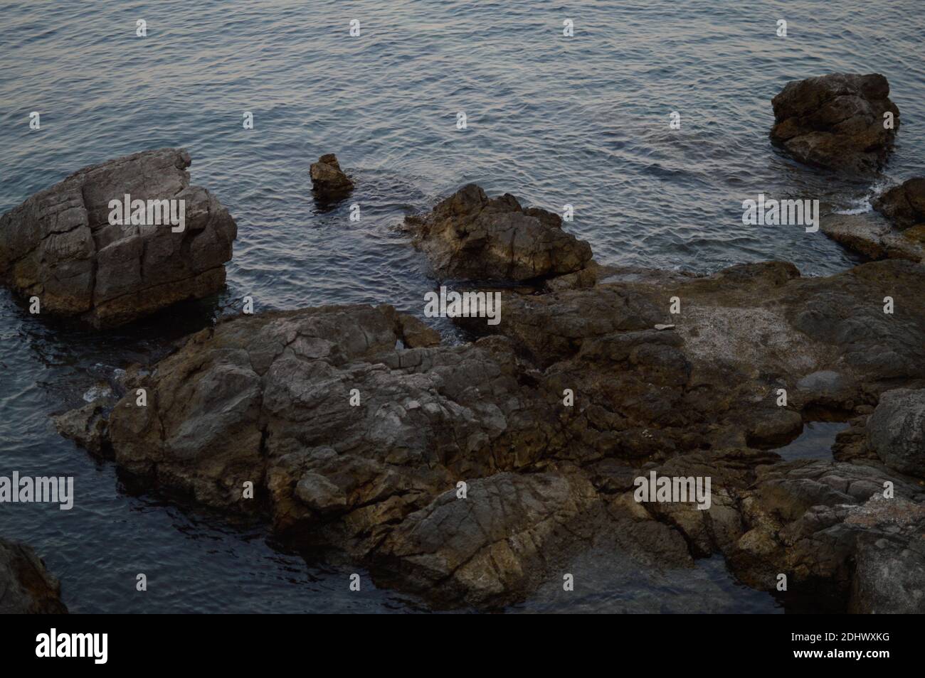 Rocks at the beach, calm water, small waves, clear water Stock Photo ...