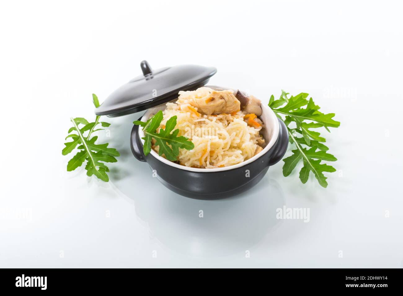 light boiled rice with vegetables and meat in a ceramic bowl isolated ...