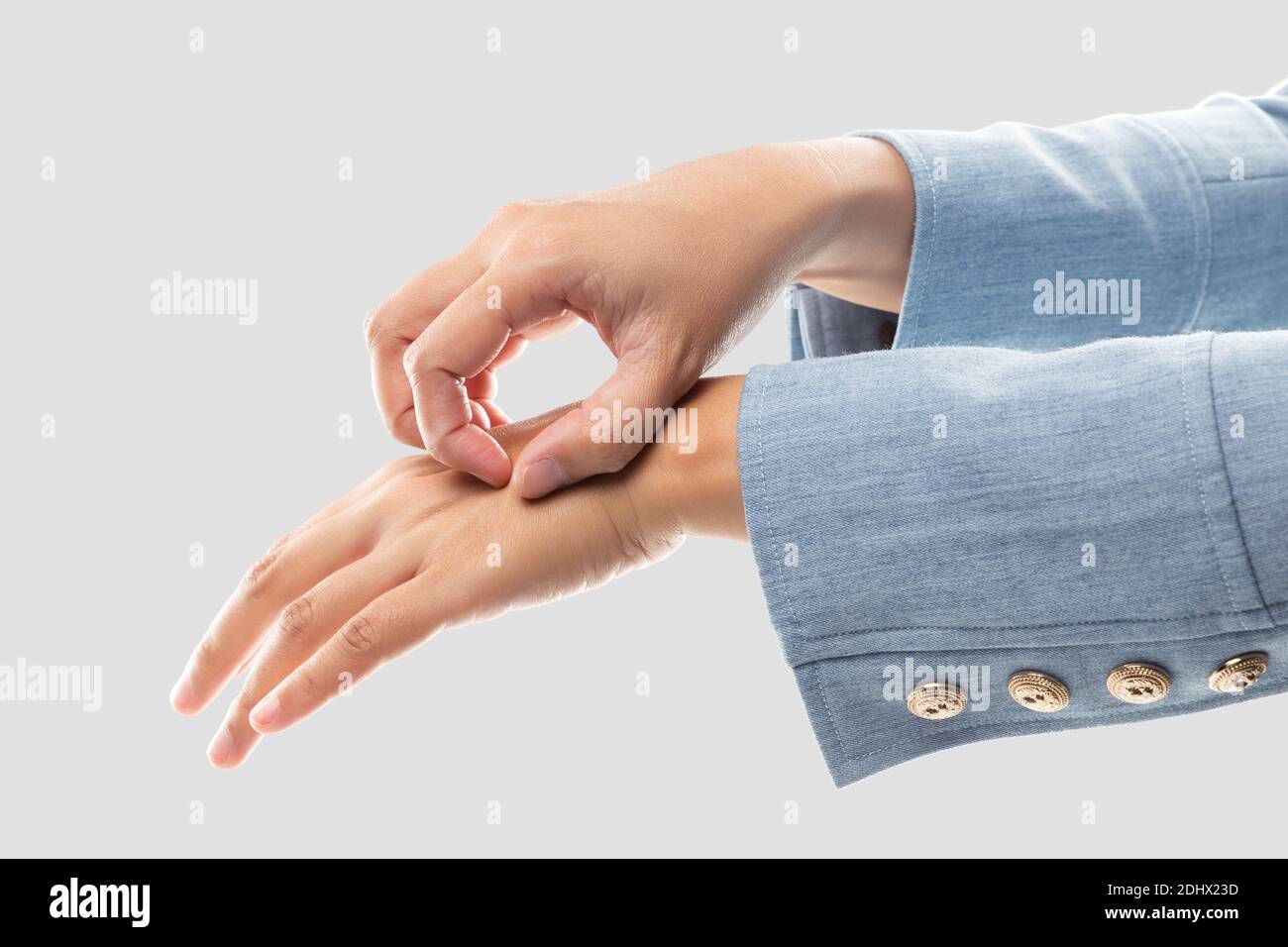 Businesswoman scratching her back of hand because of the itching from ...