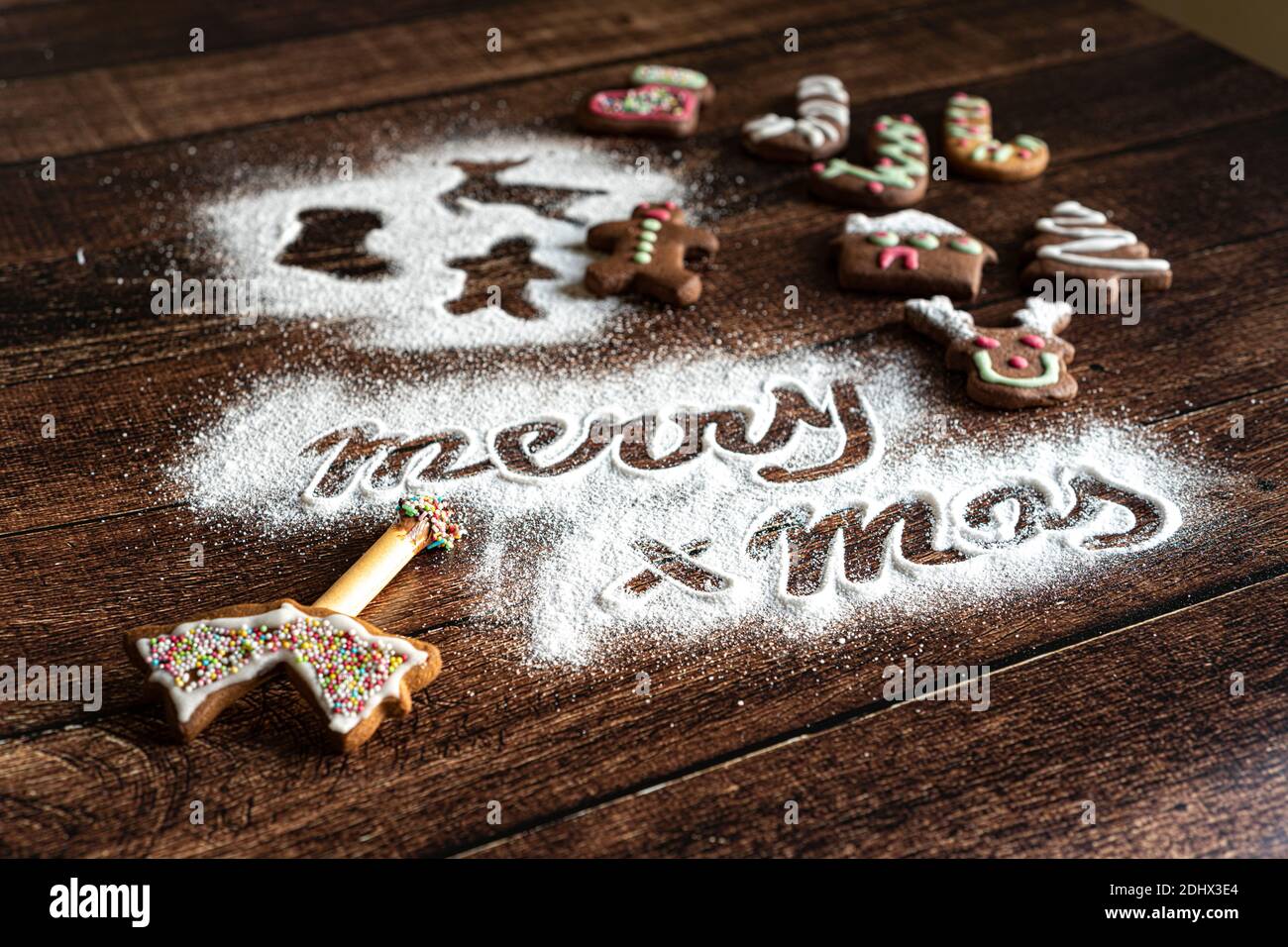 Gingerbread cookies and Merry Christmas greetings text in icing sugar ...