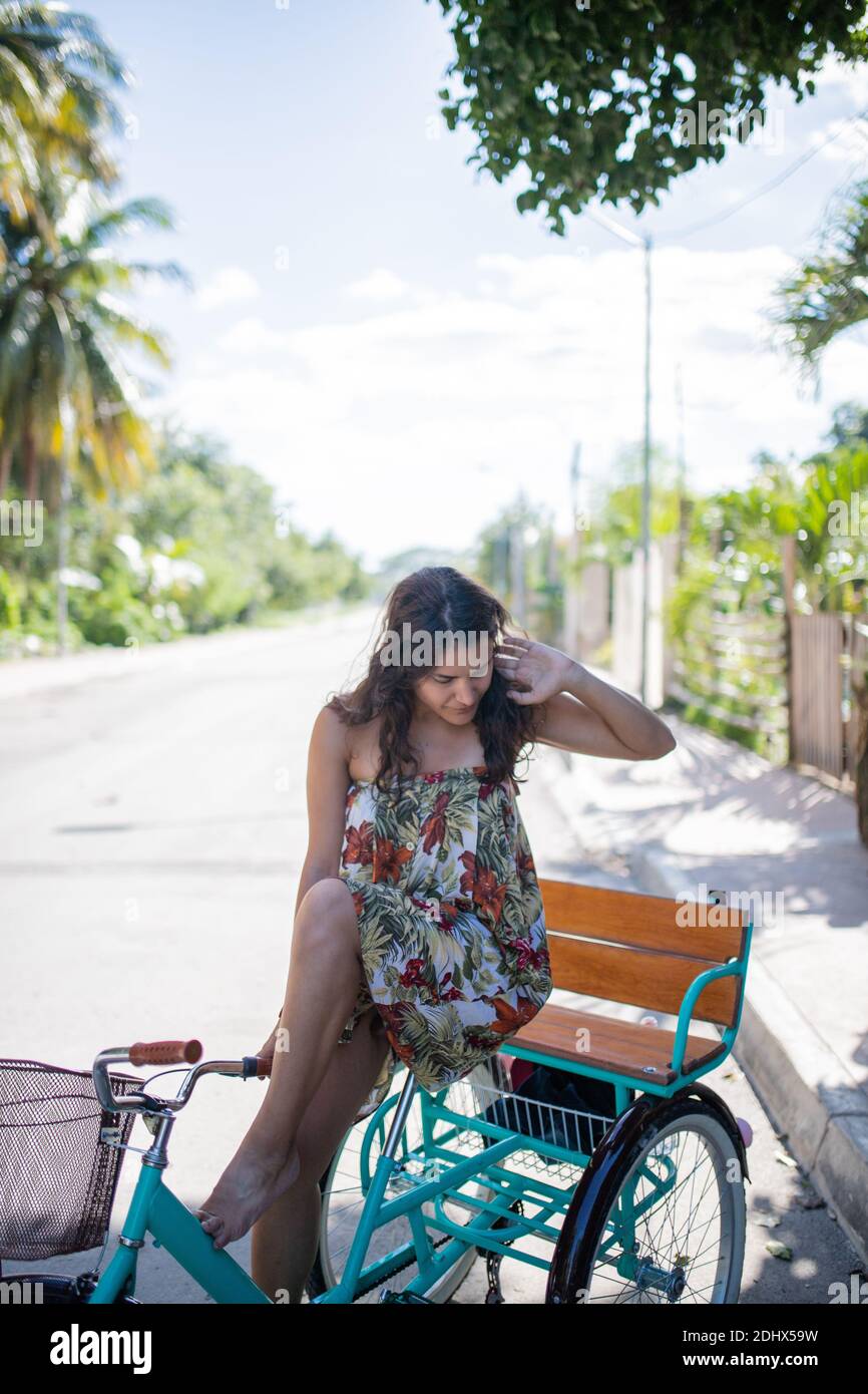 Beautiful woman wearing a dress and riding an adult tricycle Stock ...
