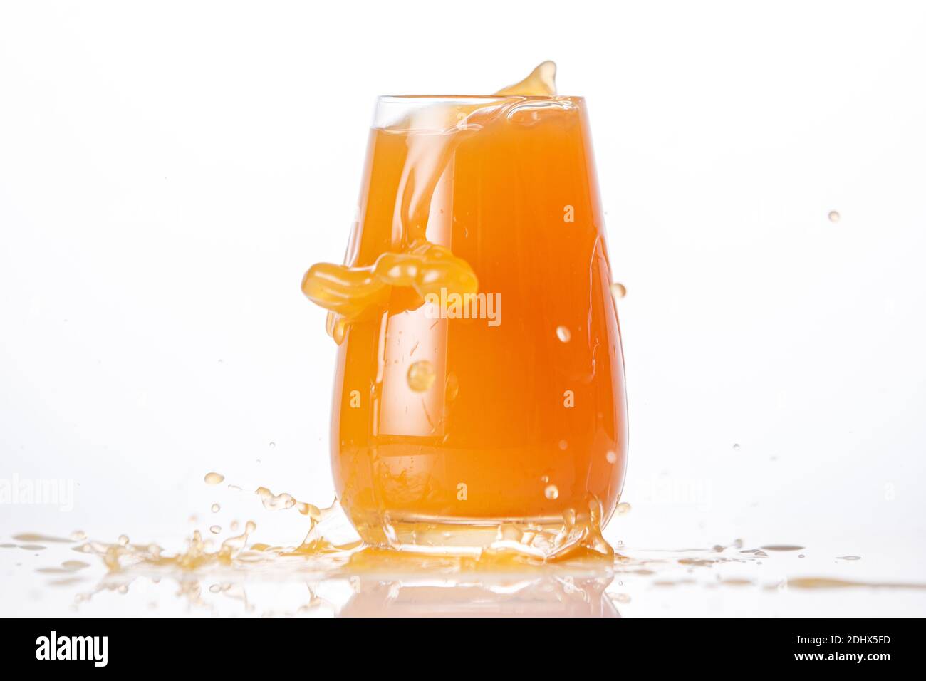 The glass of splashing fruit juice isolated on white background Stock ...