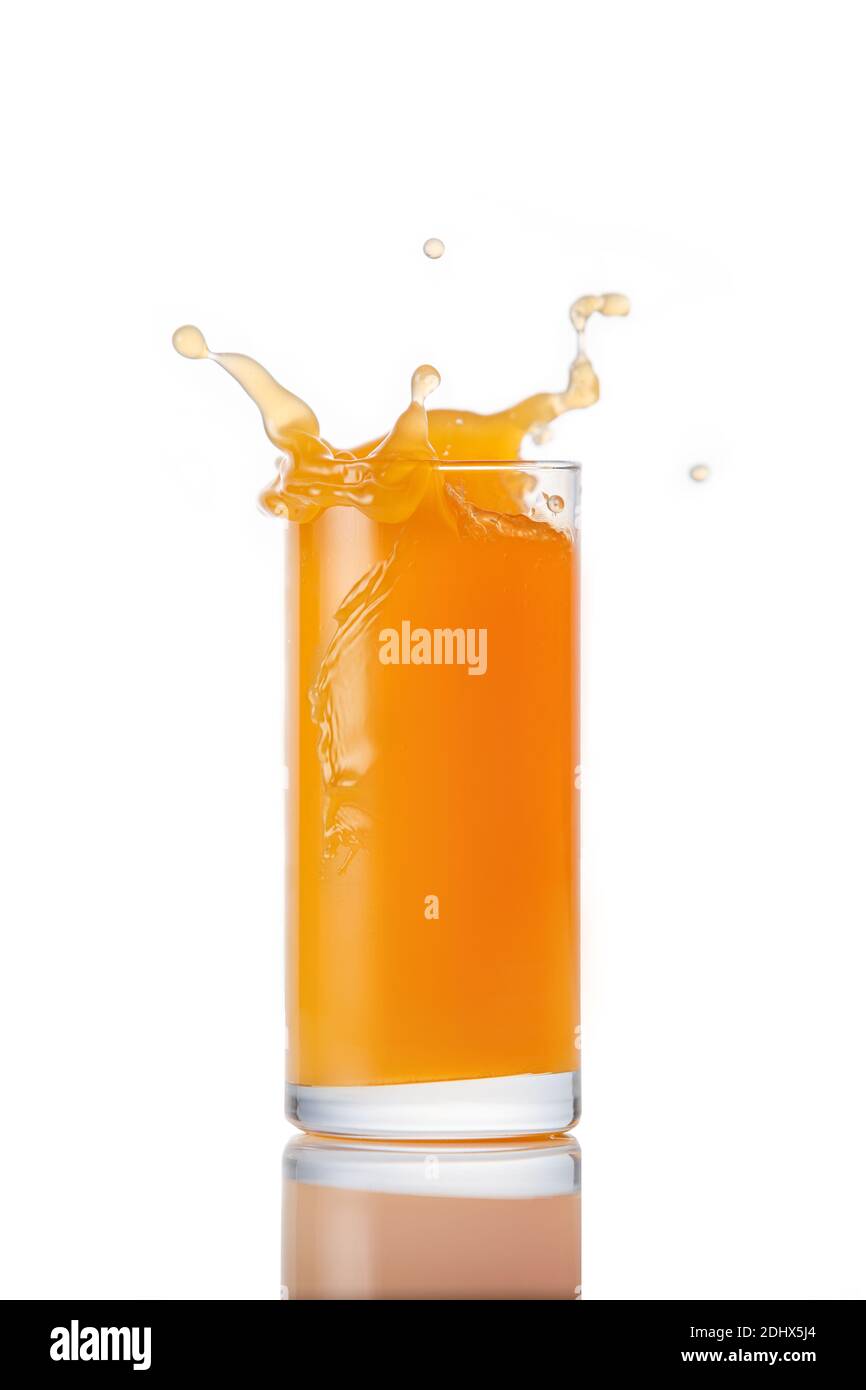 The glass of splashing fruit juice isolated on white background Stock ...